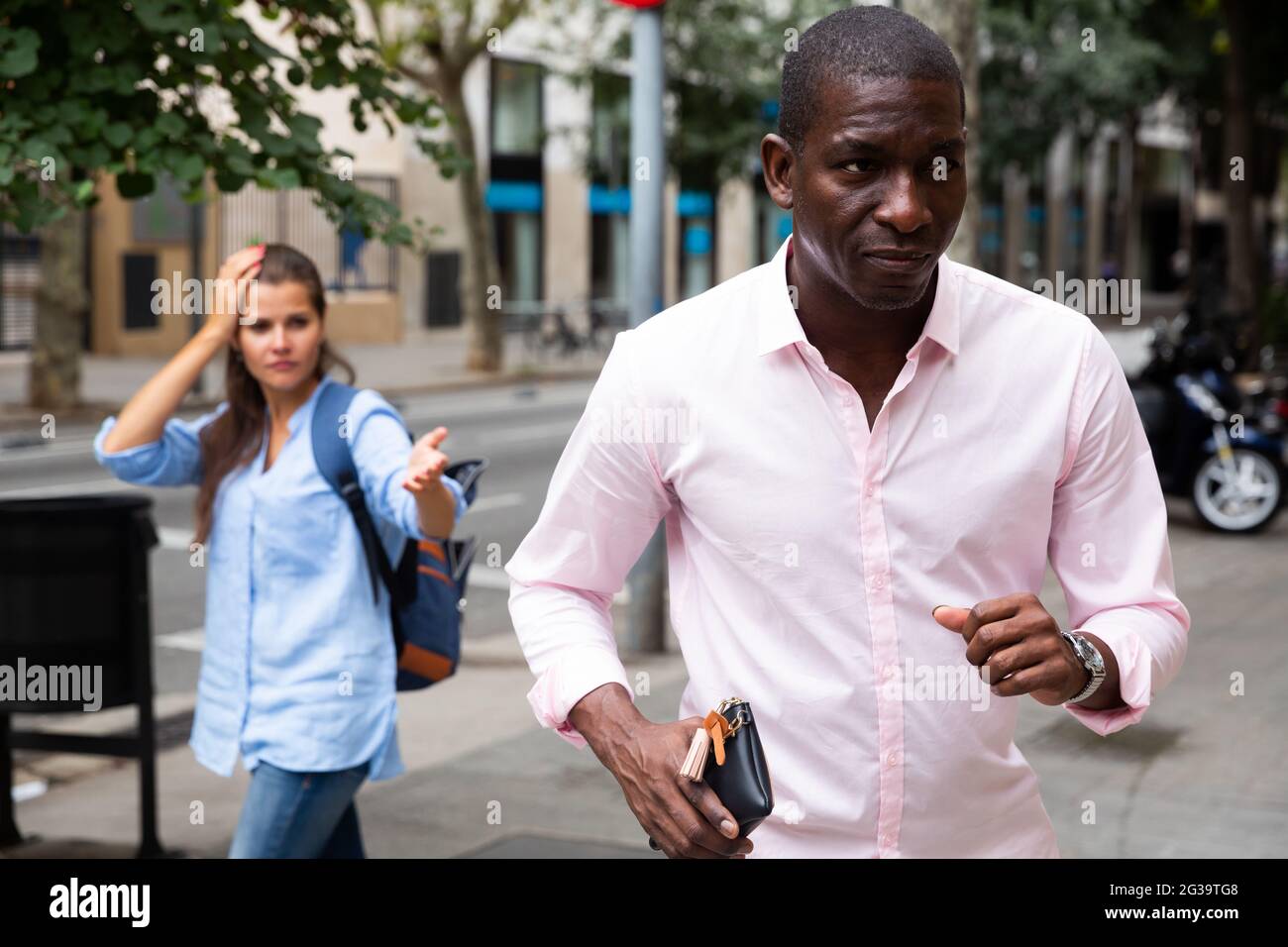 Man running away with stolen wallet Stock Photo - Alamy
