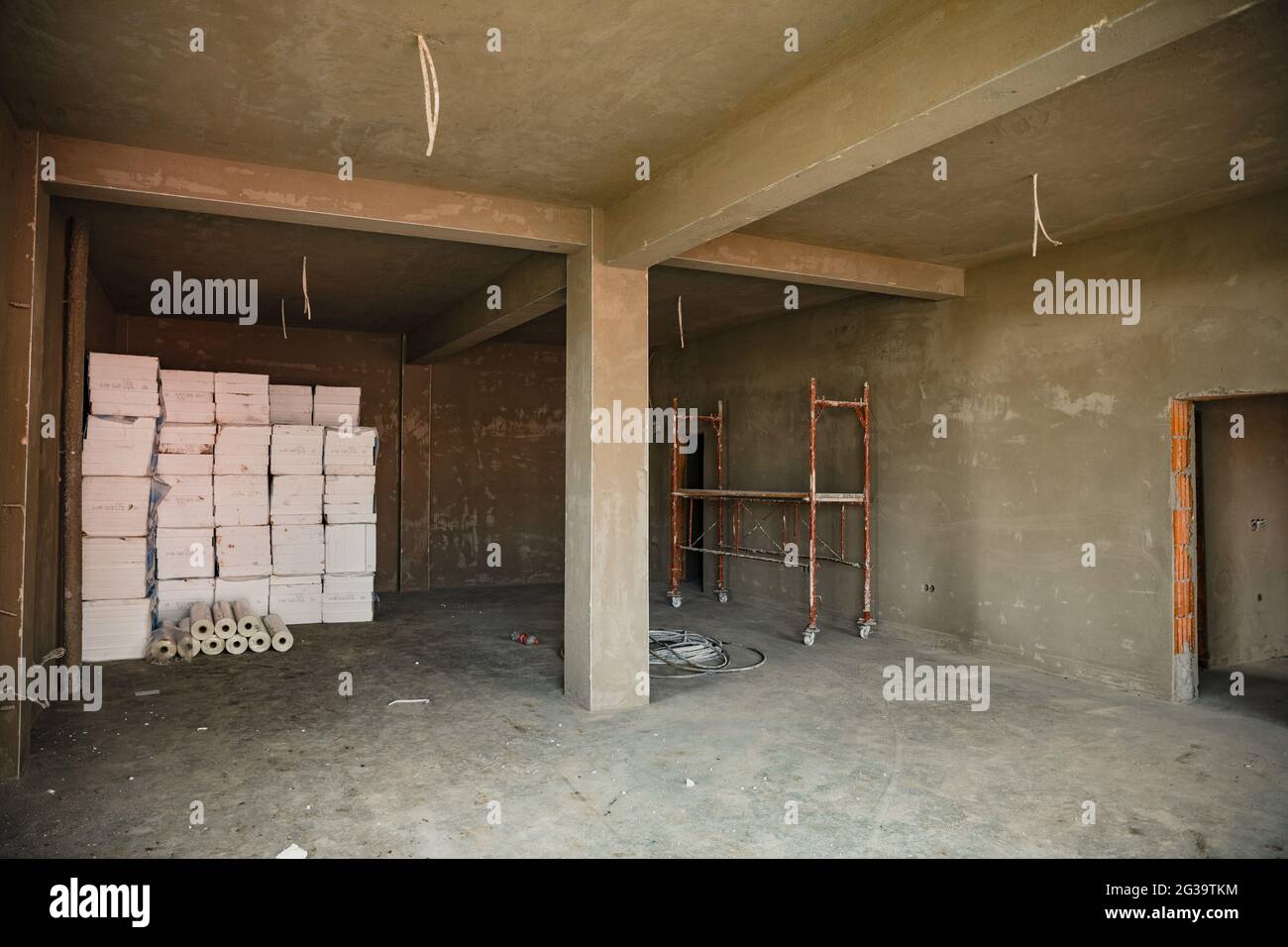 Indoor construction site with construction material, concrete walls and ...