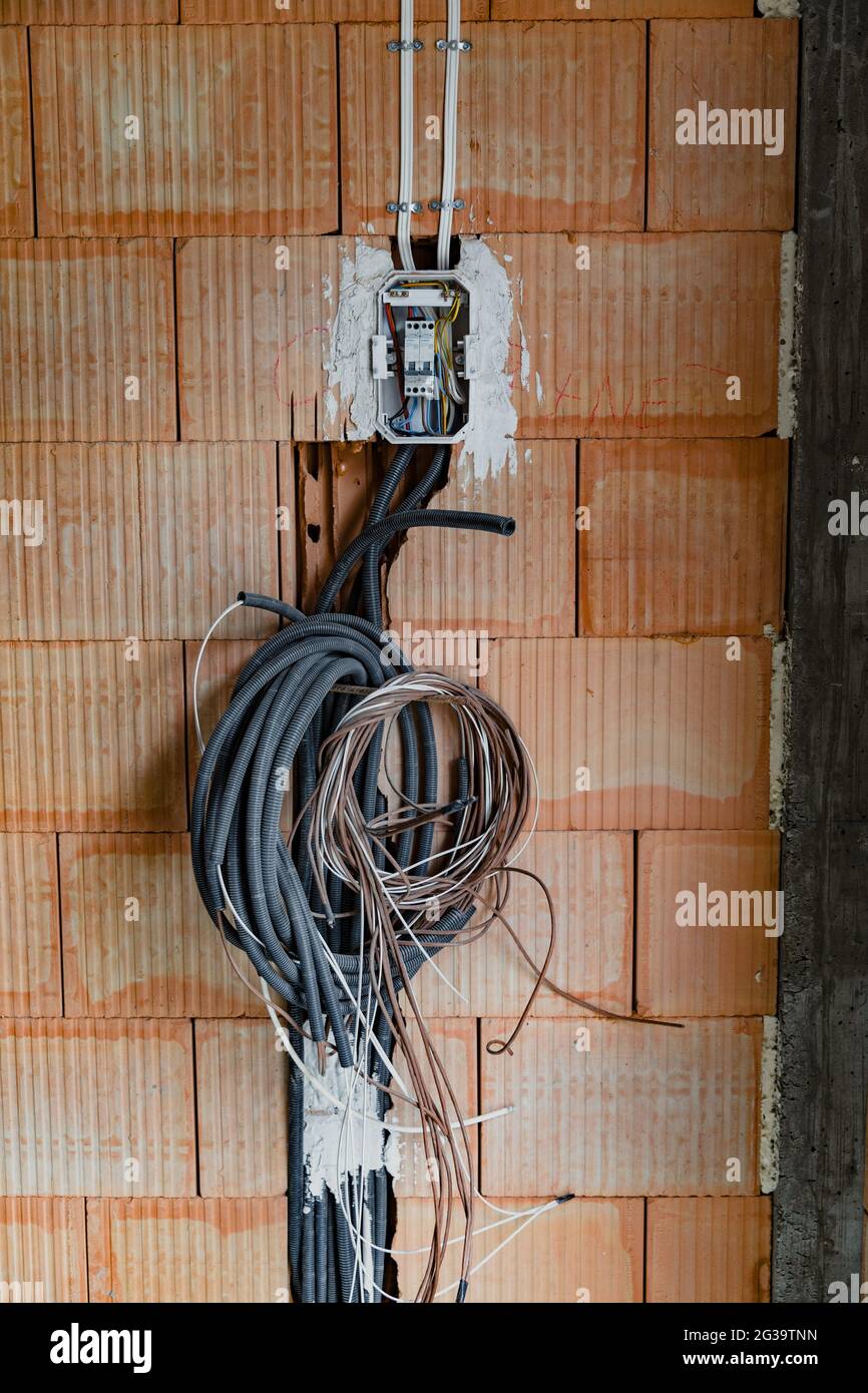 Vertical shot of the frost-resistant electrical cable coil on the brick ...