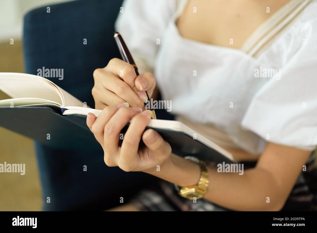 Top view of female handwriting on schedule book while working in ...