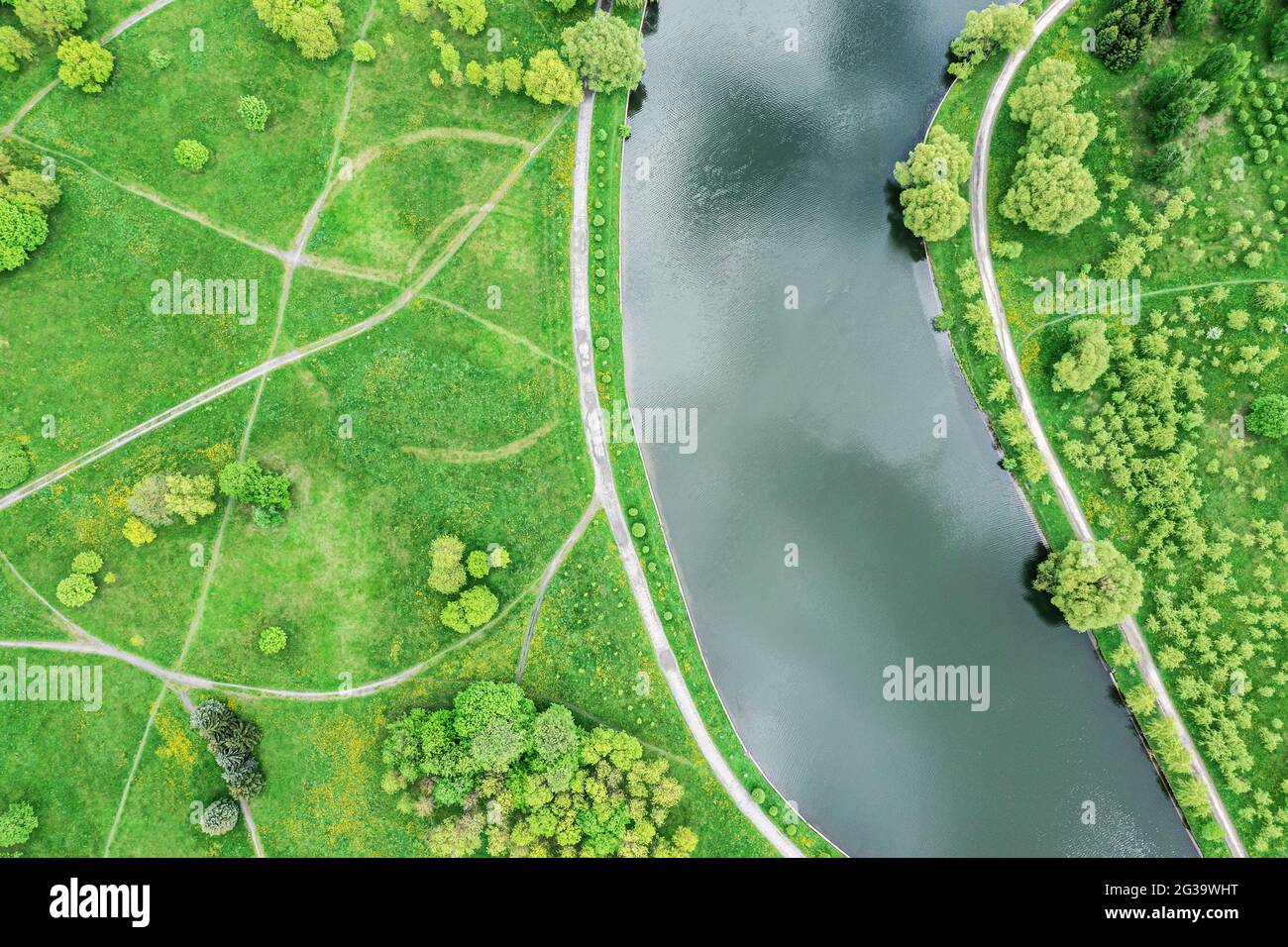 aerial top view of the river with cloudy sky reflections and green lawn ...