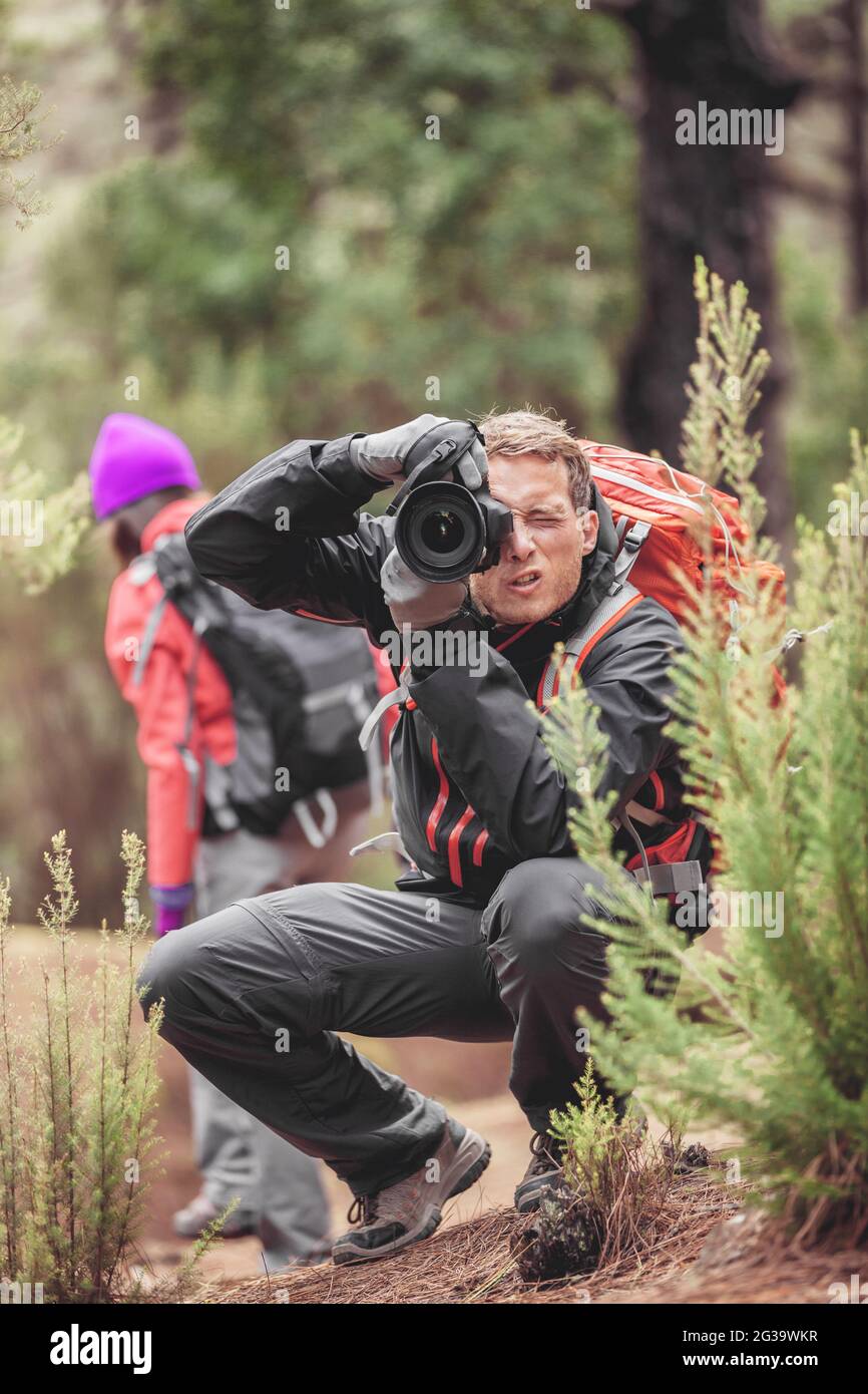 Photographer man taking pictures with professional camera of wildlife ...