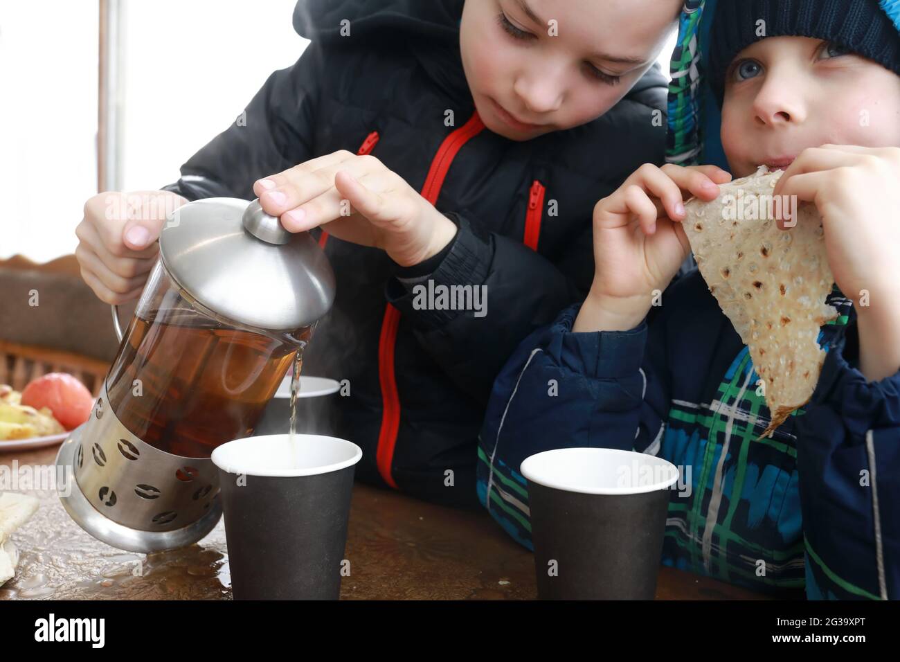 Child pouring herbal tea in a restaurant Stock Photo - Alamy