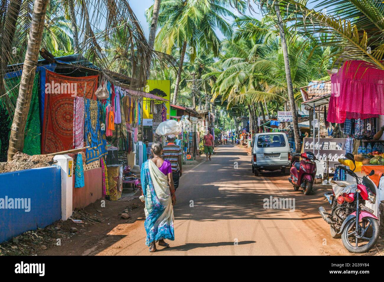 Indian female in sari walks along colourful Agonda Beach Road, Agonda ...