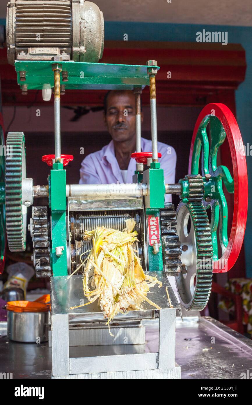 Indian male operating Akshar sugarcane cane crusher juice machine ...