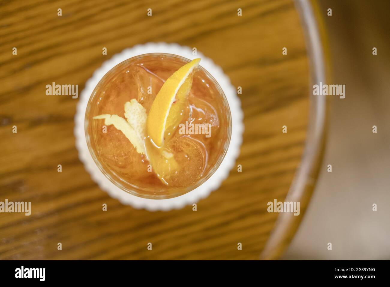 Top view of a refreshing cocktail with ice cubes and orange slice on a ...
