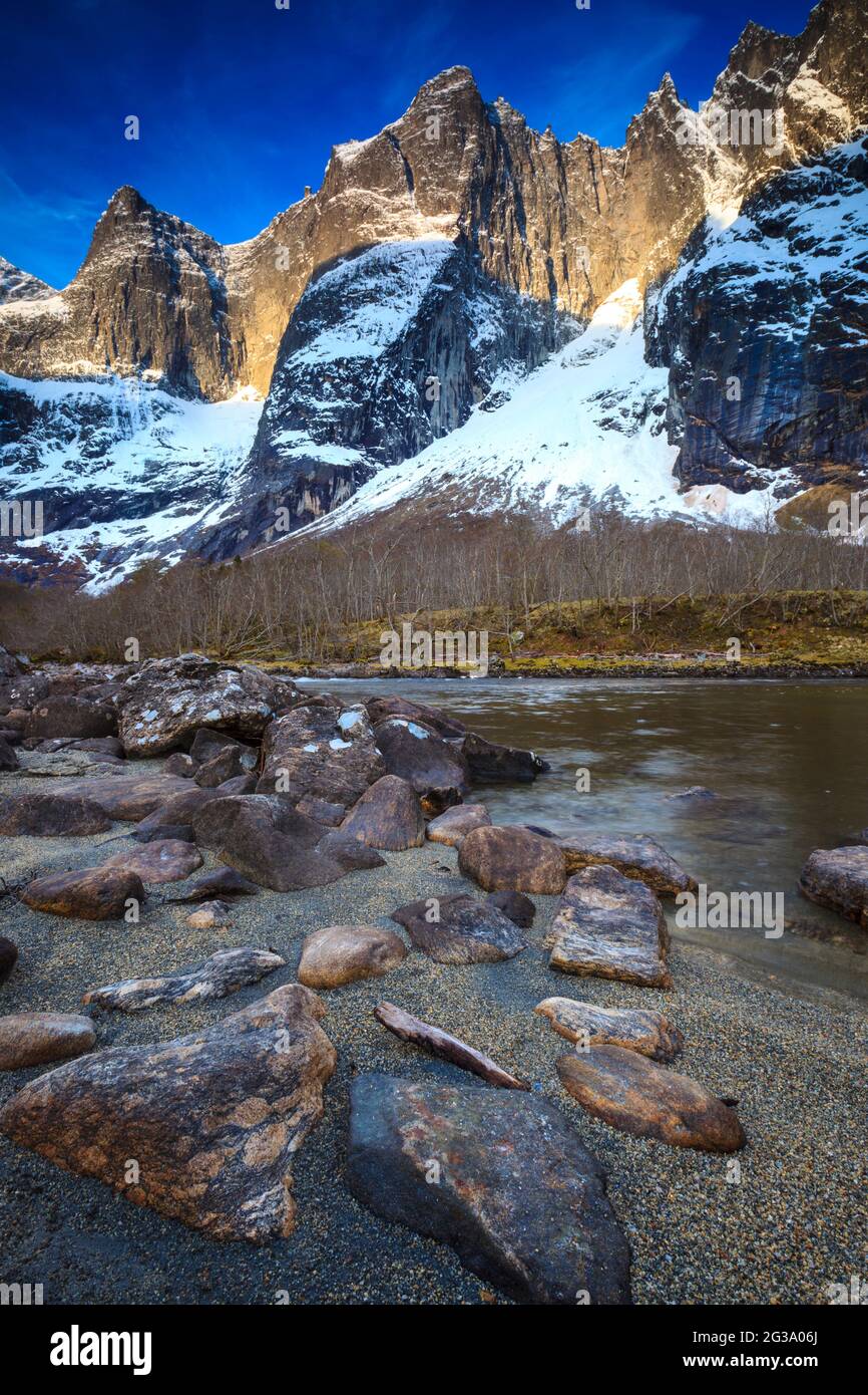 Early morning sunlight on the peaks Trolltindene and Trollveggen, or ...