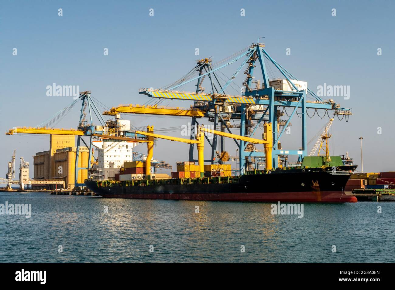 Container ship under flag of Liberia being loaded with containers and ...