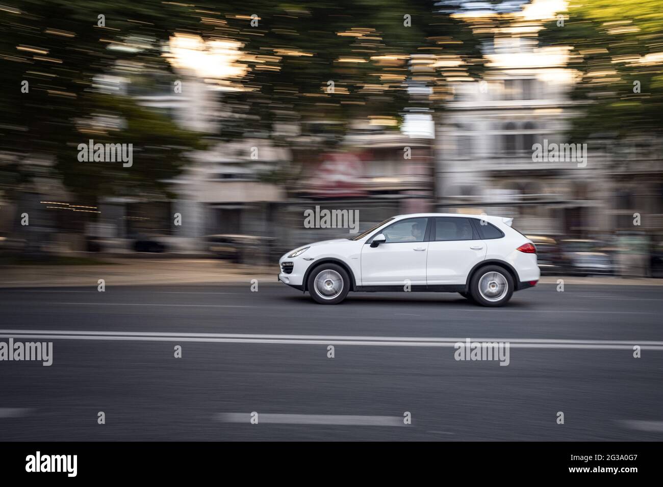 Fast-moving white car on the road with blurred background Stock Photo ...