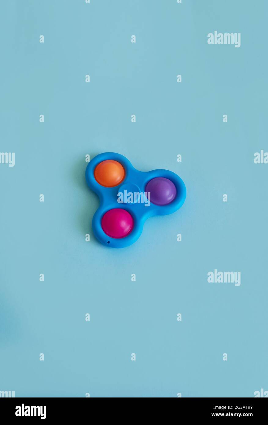 Silicone Toy Spinner Simple Dimple. Blue background. Vertical format ...