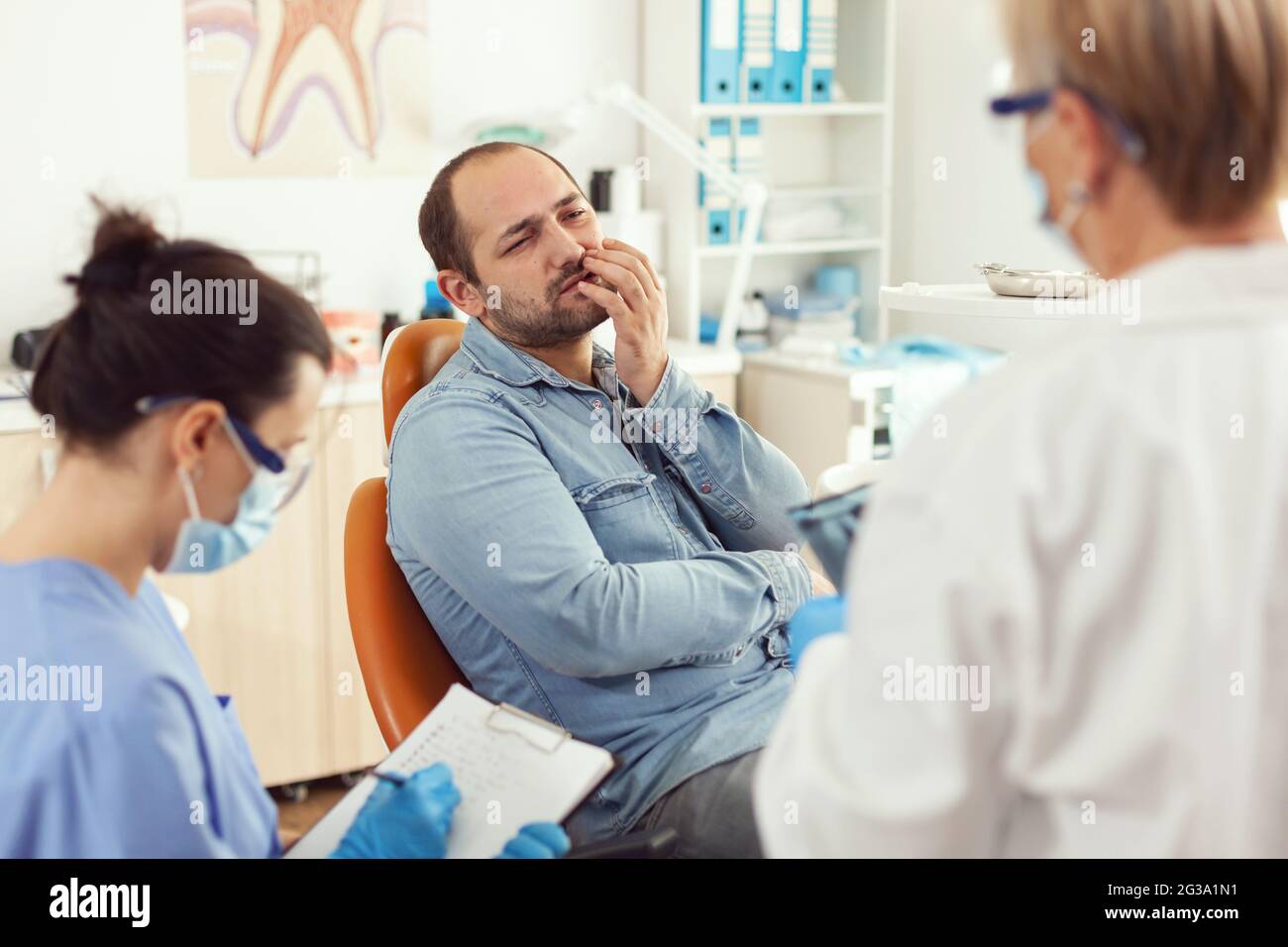 Sick patient with toothache speaking with stomatologist showing ...