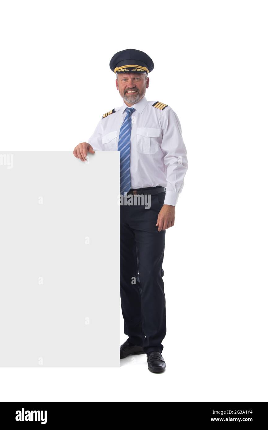 Full length portrait of happy smiling pilot holds blank banner isolated ...