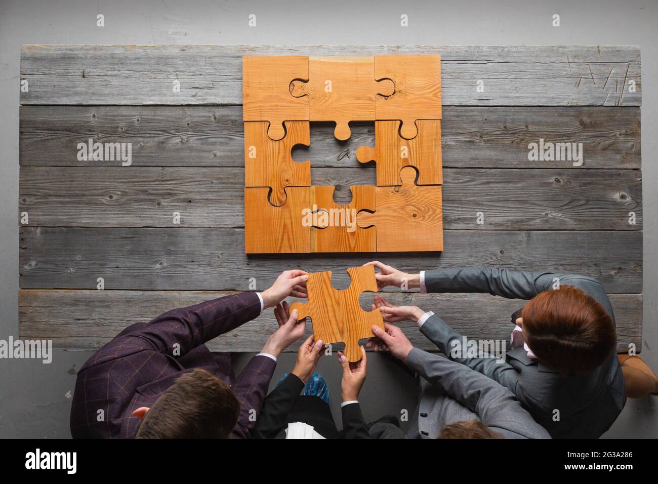 Business teamwork with puzzle finishing project cooperation unity ...