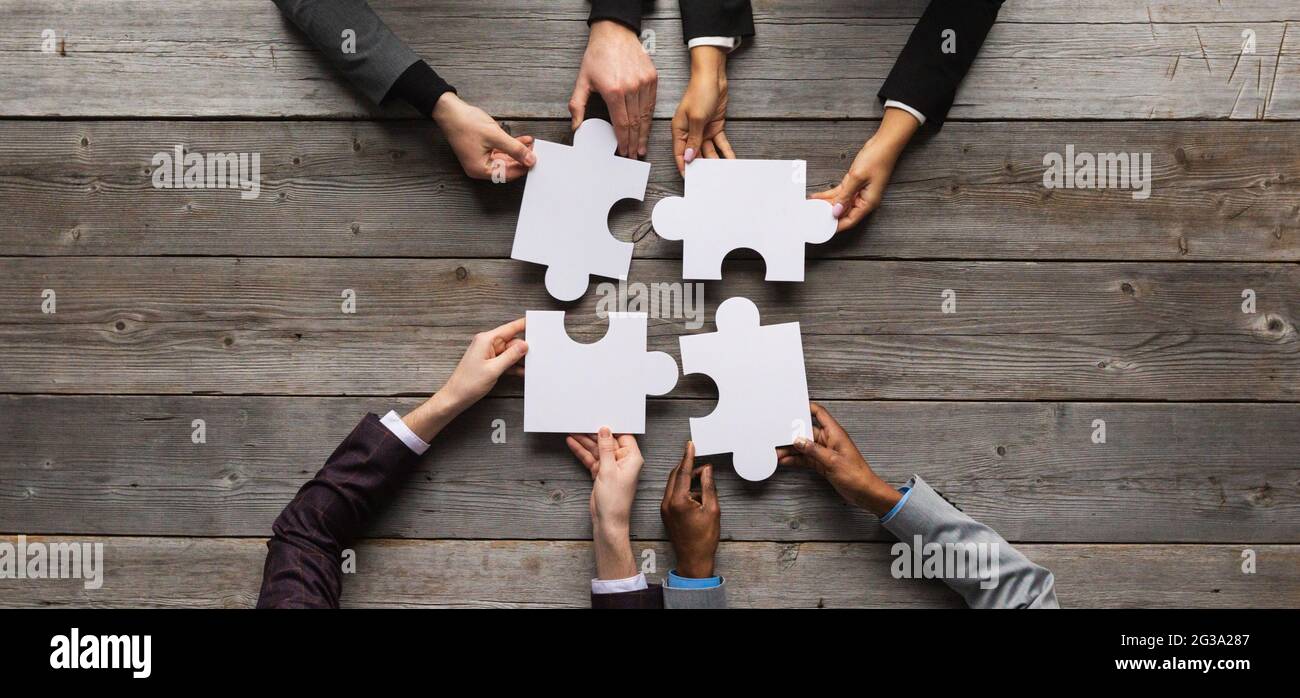 Business teamwork with white puzzle of four pieces cooperation unity ...