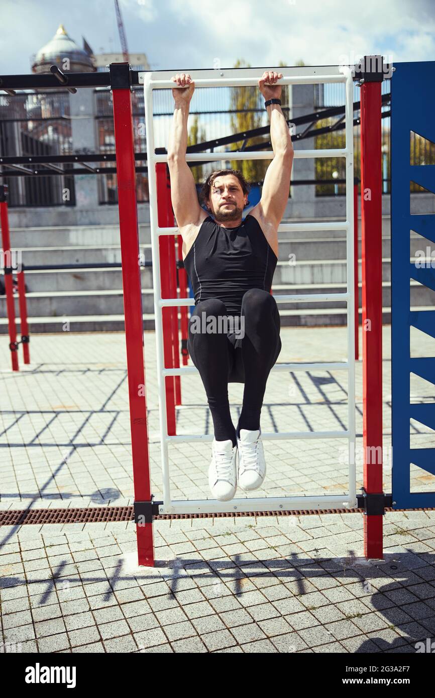 Handsome sportsman pulling up hi-res stock photography and images - Alamy