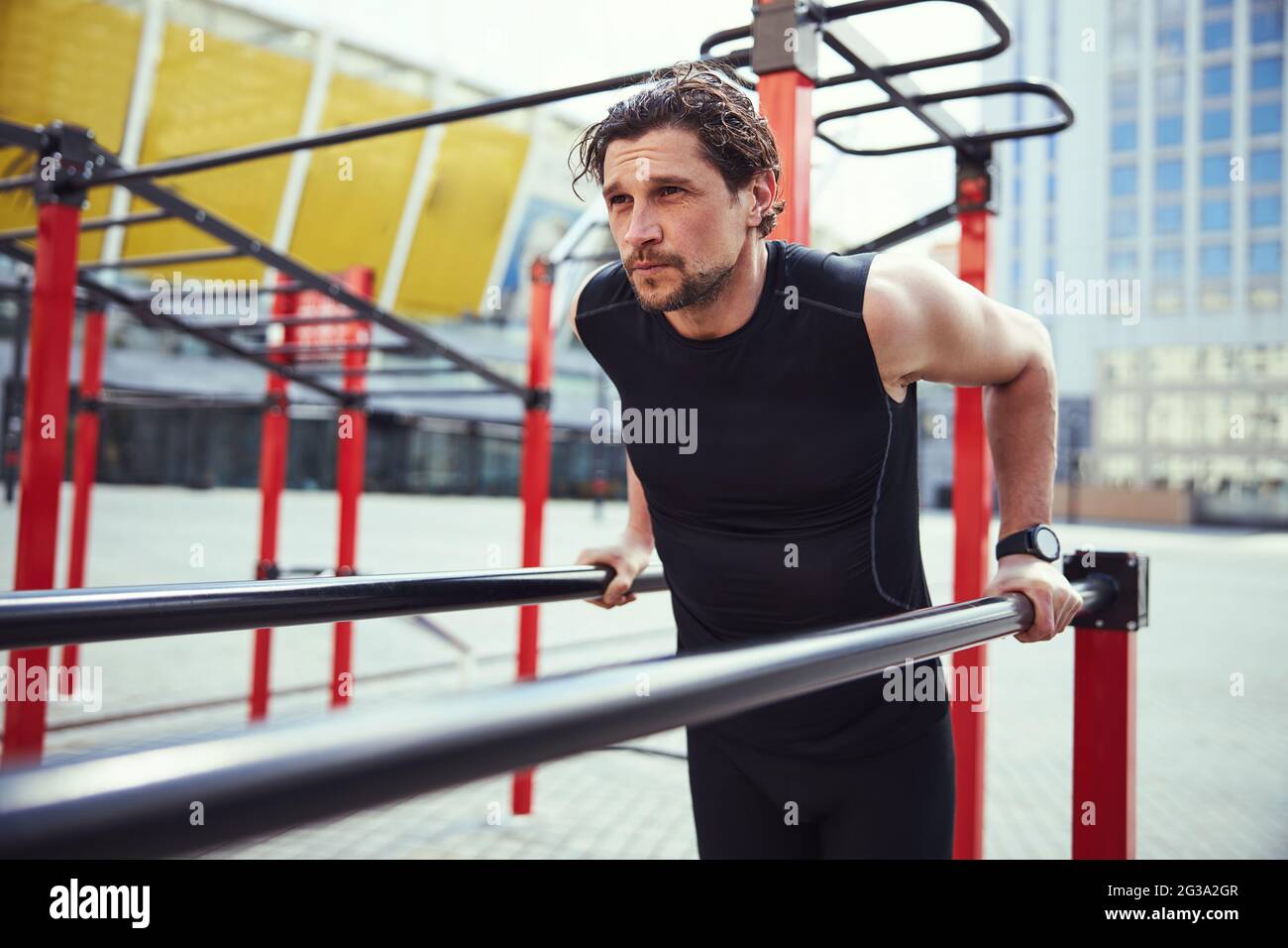 Thoughtful man holding bars with both hands Stock Photo - Alamy