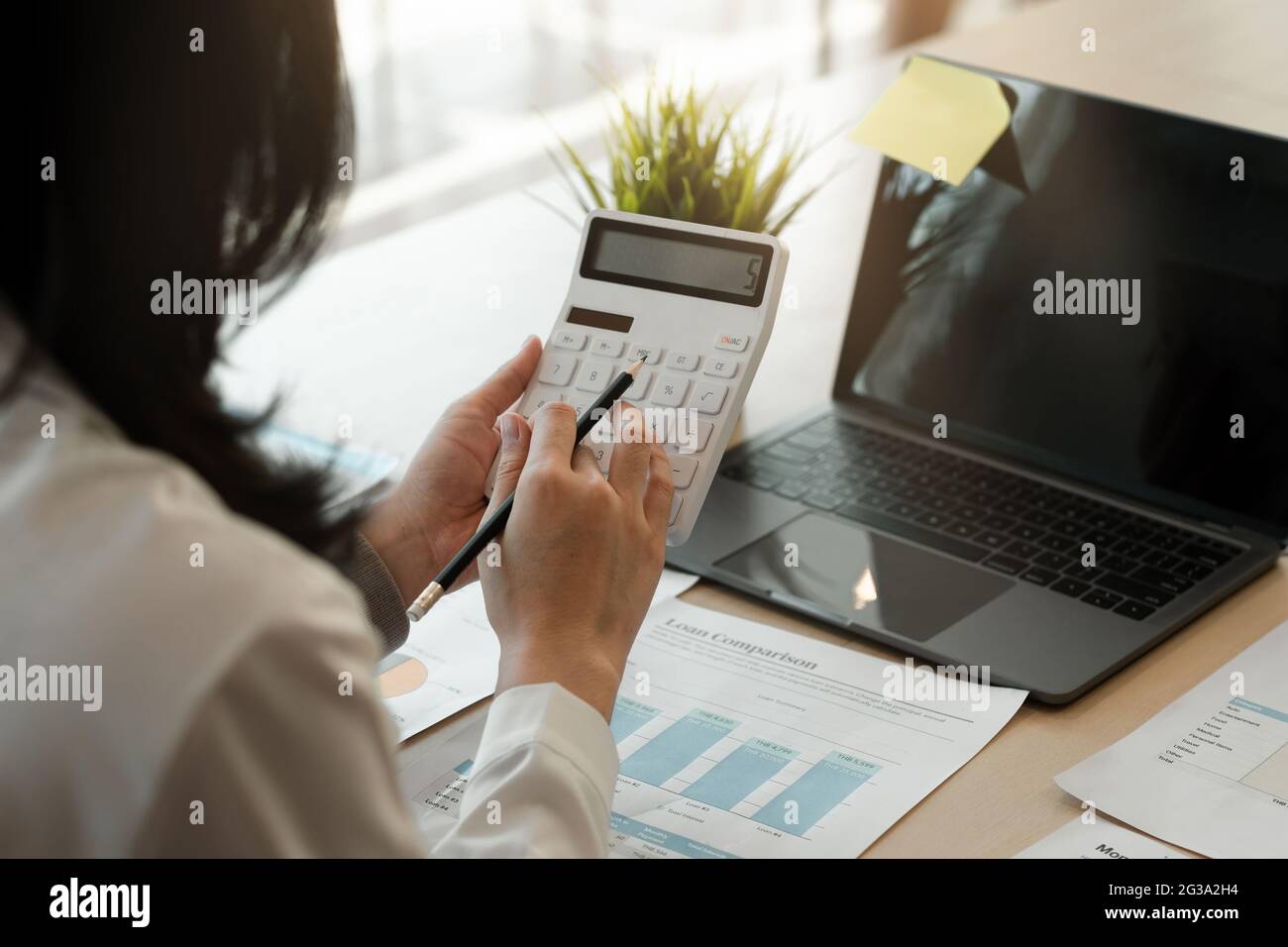 businesswoman working on desk office with using a calculator to ...