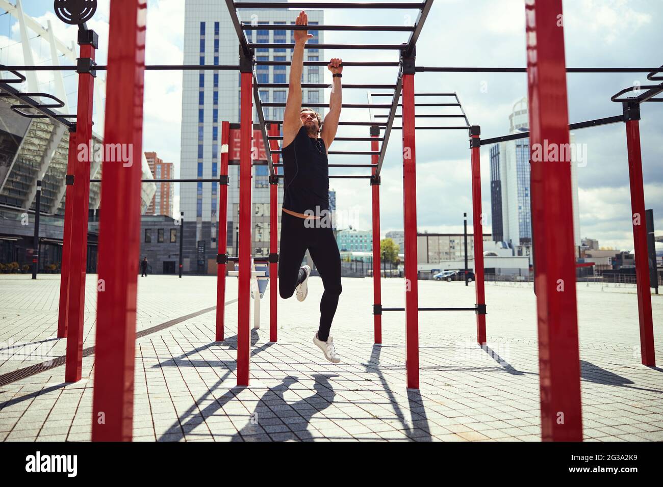 Concentrated male person walking on horizontal bar Stock Photo - Alamy