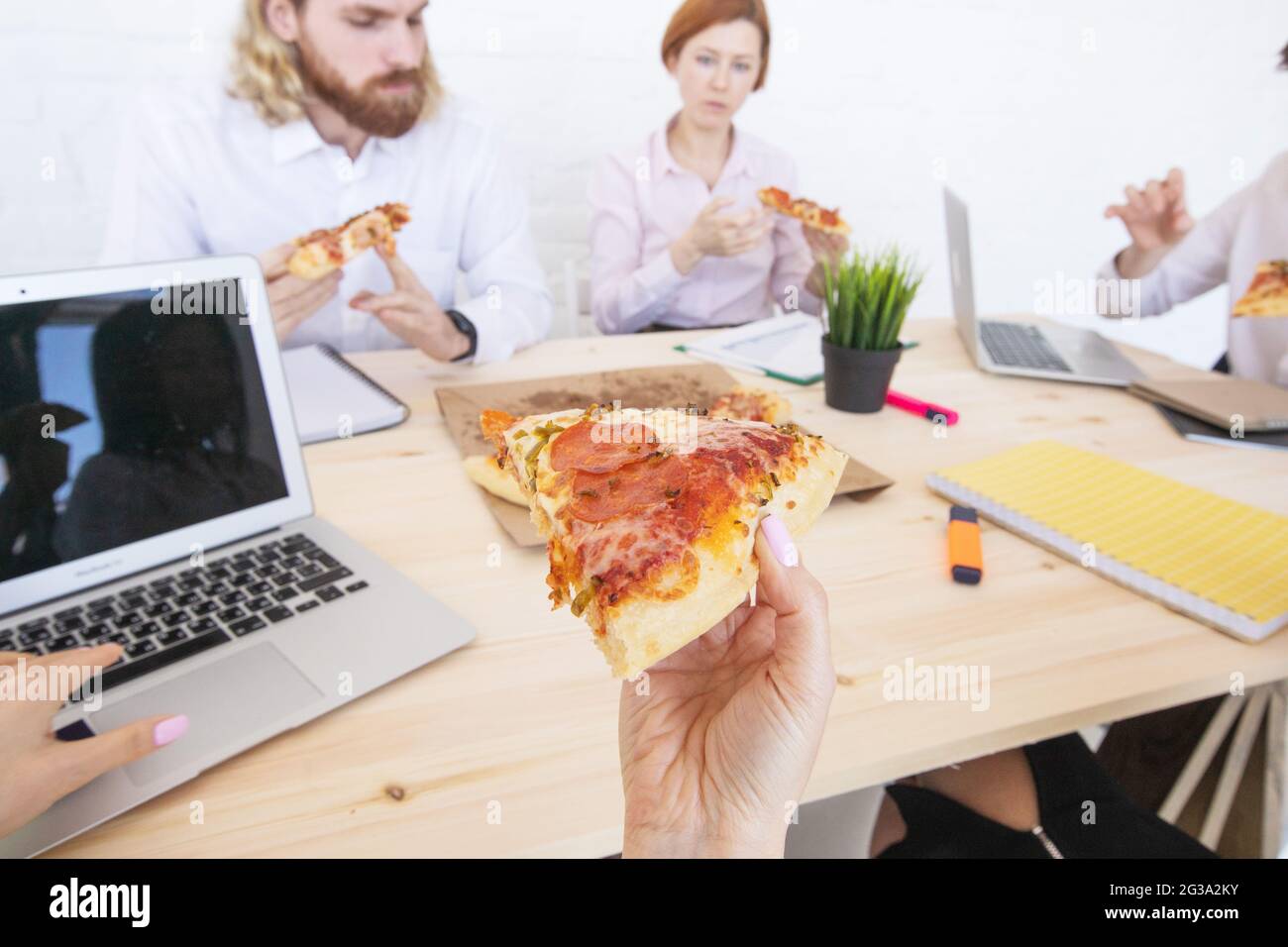 Group Of Diverse Business People Eating Pizza At Break While Working