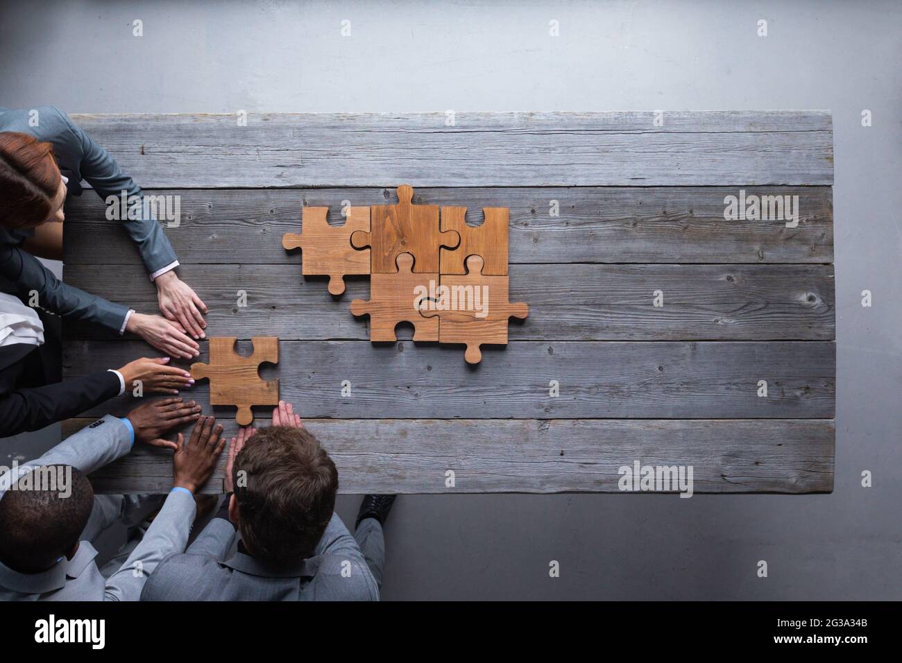 Business teamwork with puzzle finishing project cooperation unity ...
