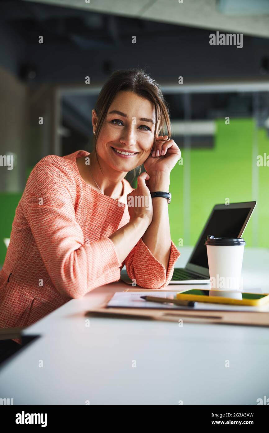 Beautiful young female internet marketing specialist looking and posing ...