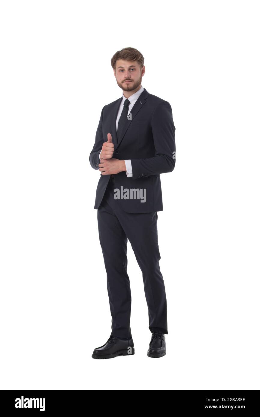 Full length of handsome businessman in formal wear giving thumbs up ...