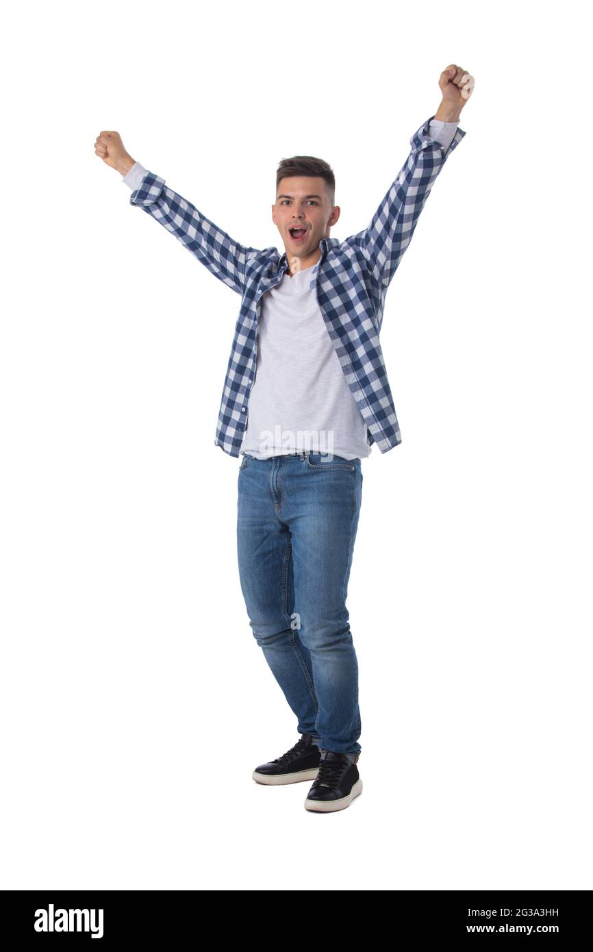Full length portrait of a young man with arms raised isolated on a ...