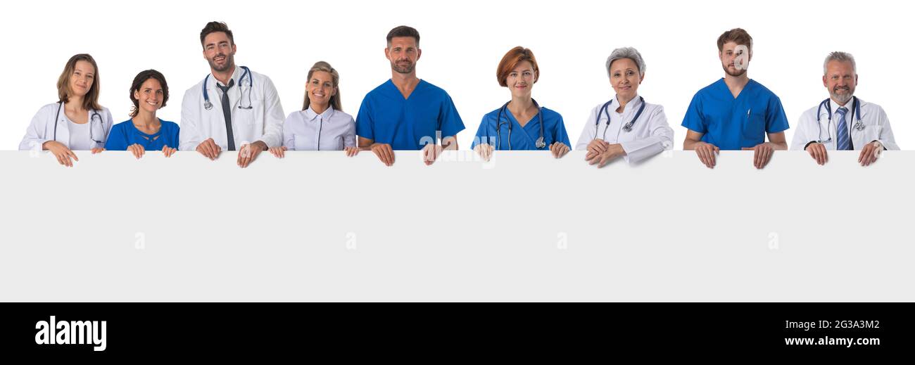 Group of doctors with blank banner isolated over a white background ...