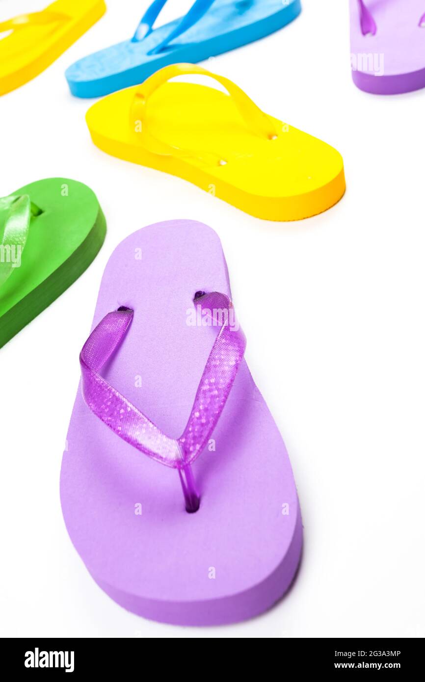 multi-colored rubber beach flip flops on a white background Stock Photo ...