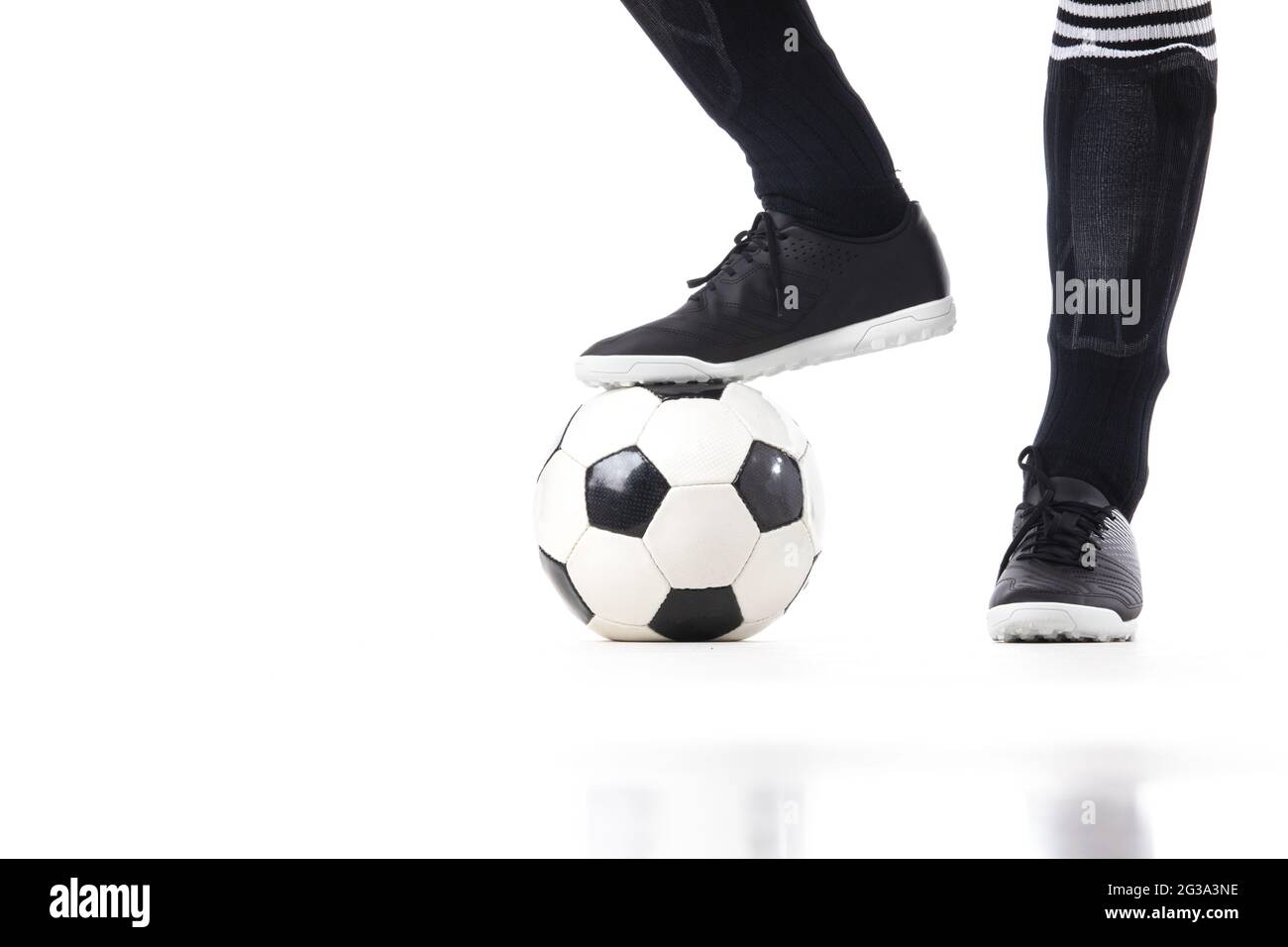 Soccer ball under soccer player's feet, isolated on white background ...