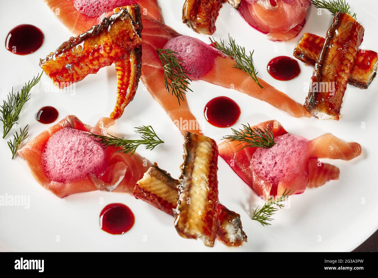 Smoked eel and salted salmon with beet foam and unagi sauce Stock Photo ...