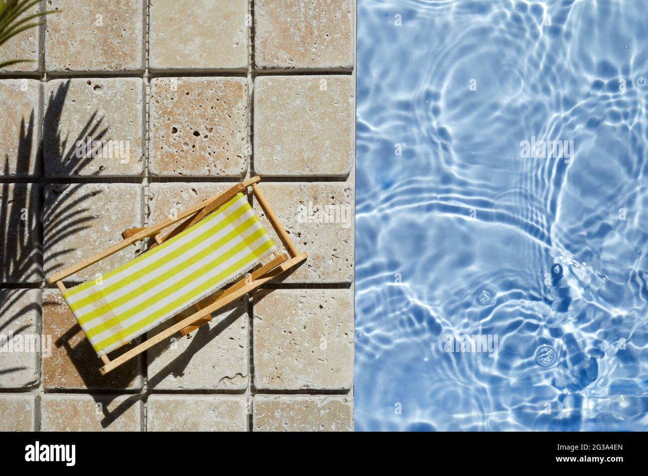 Swimming pool and empty resting chair with shadow. Top view Stock Photo ...