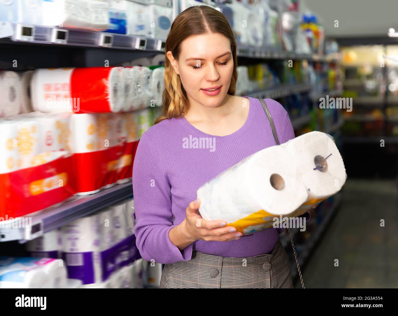 Portrait happy female holding toilet paper Stock Photo - Alamy