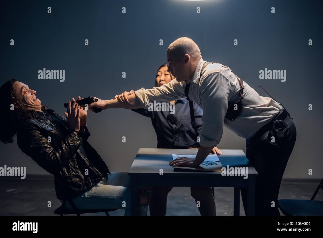 A corrupt police officer attacks a suspect in a gun trafficking case at ...