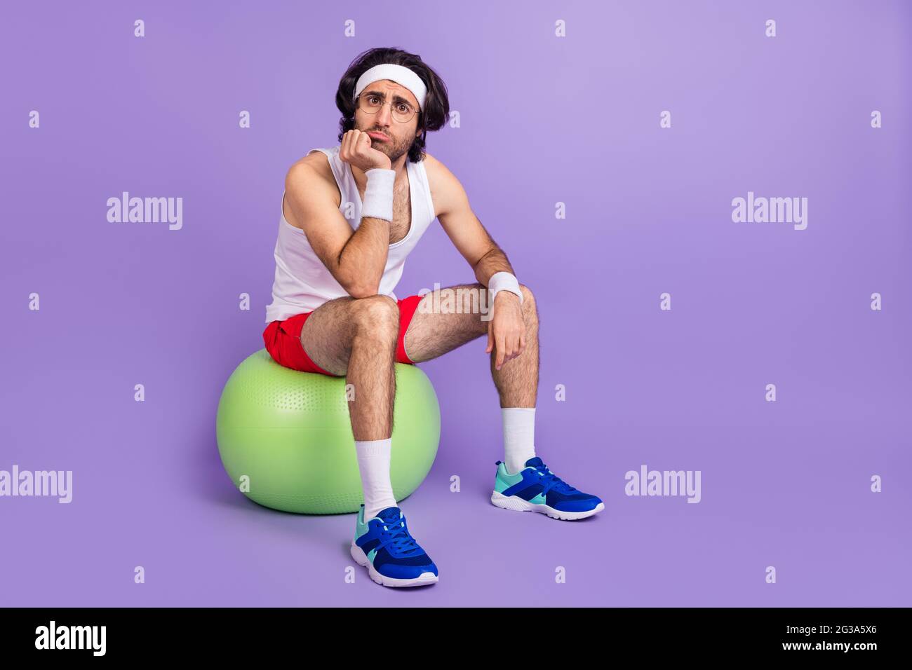 Full size photo of young unhappy upset sad athlete man in glasses sit ...