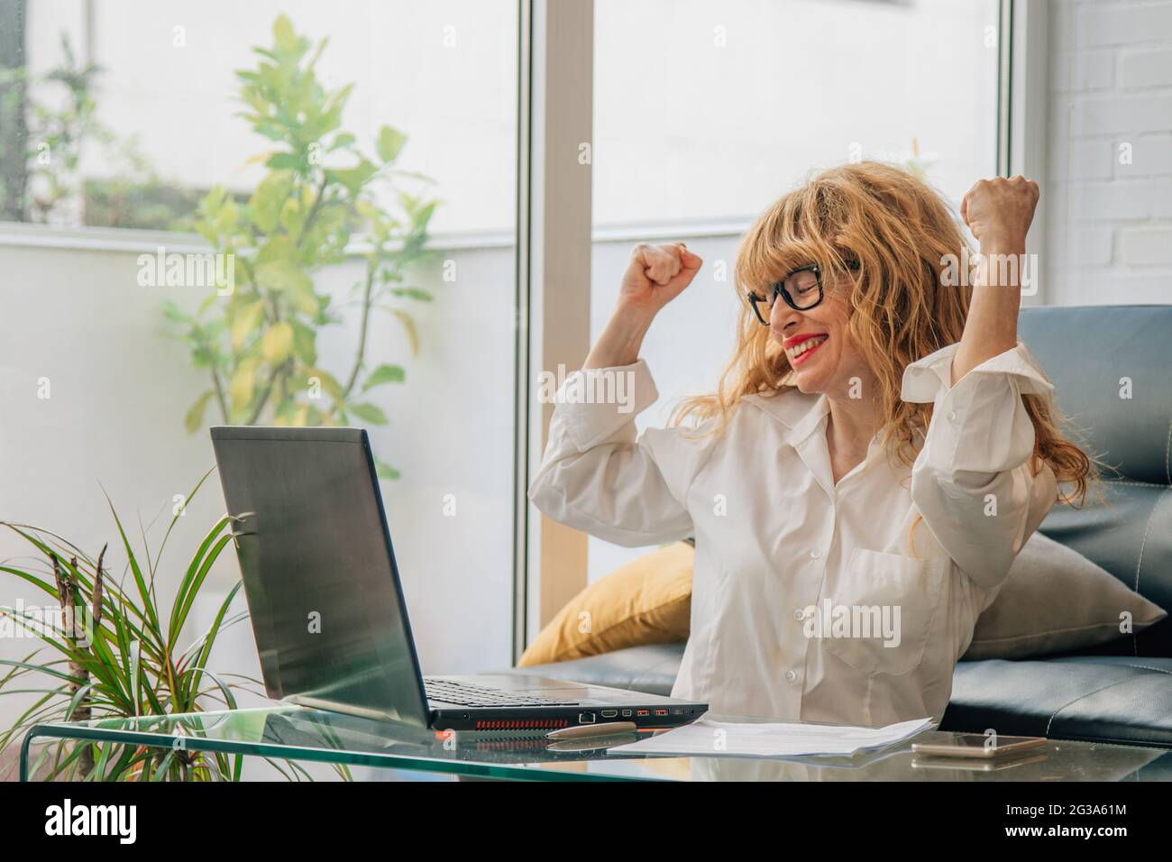 cheerful business woman at desk with computer excited Stock Photo - Alamy