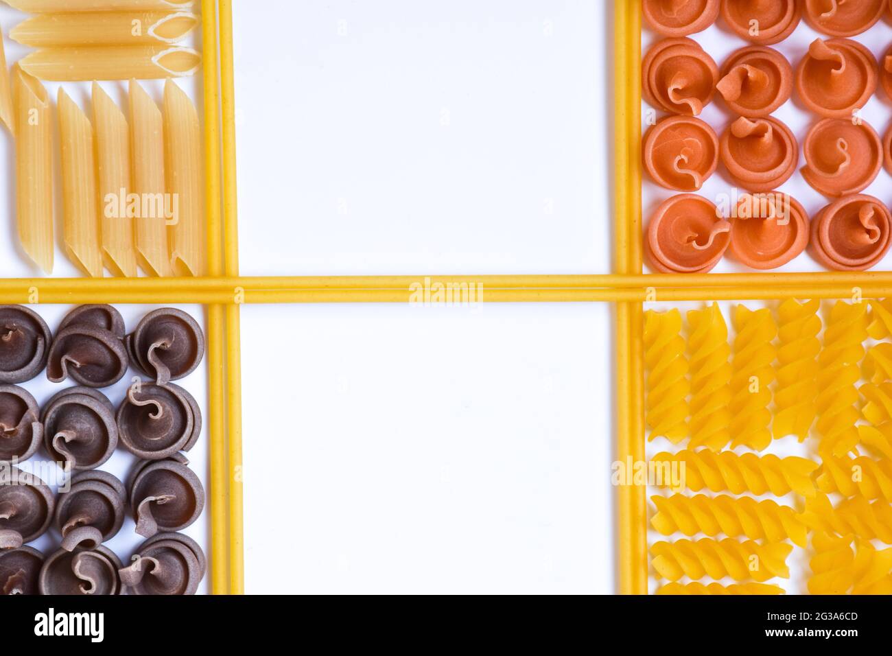 Raw pasta and spaghetti of different varieties and colors are laid out ...