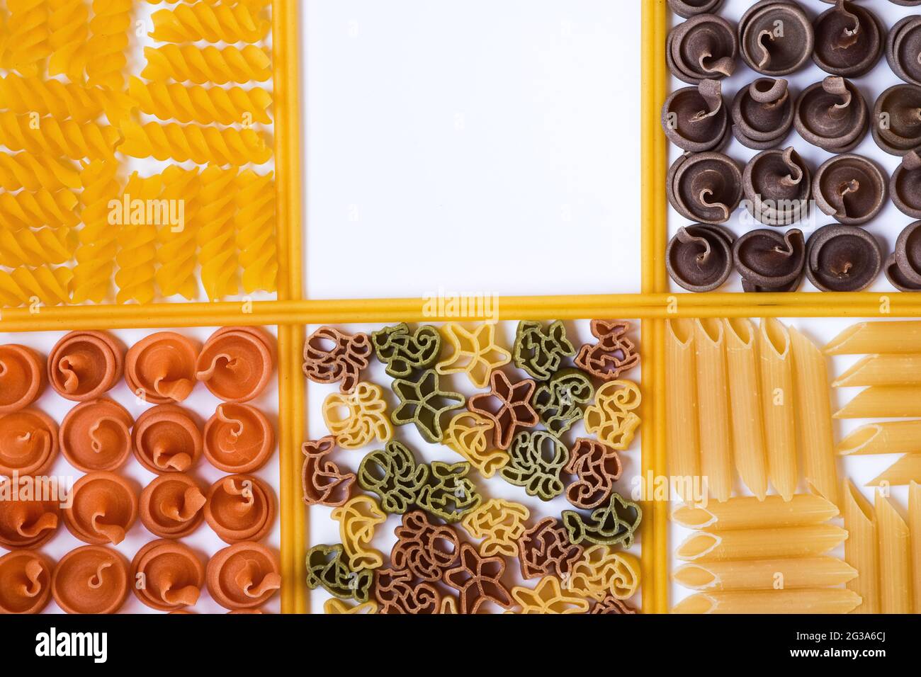 Raw pasta and spaghetti of different varieties and colors are laid out ...