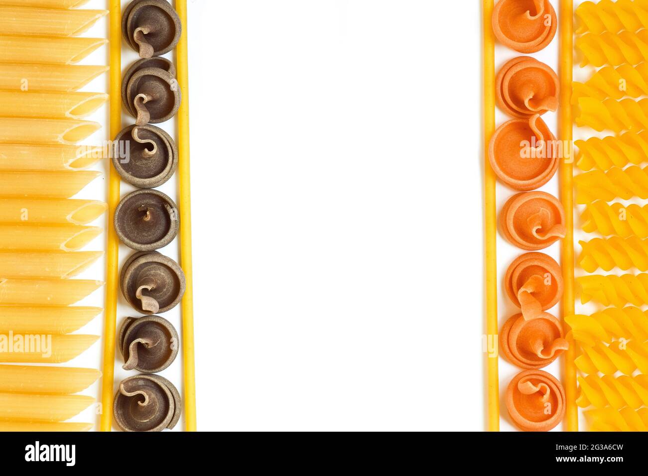 Raw pasta and spaghetti of different colors and types are laid out in a ...