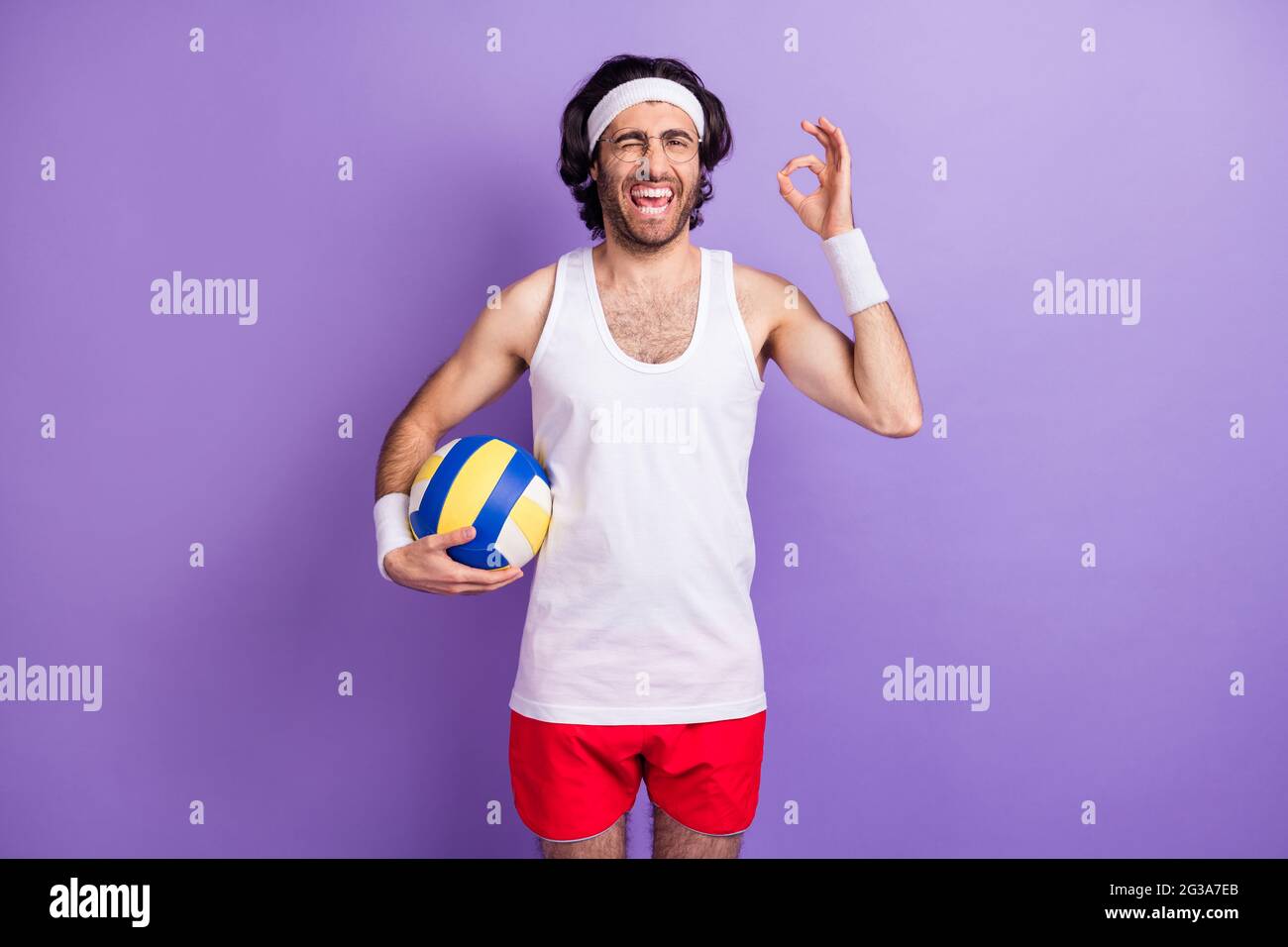 Photo of optimistic brunette guy show okey hold ball wear spectacles ...