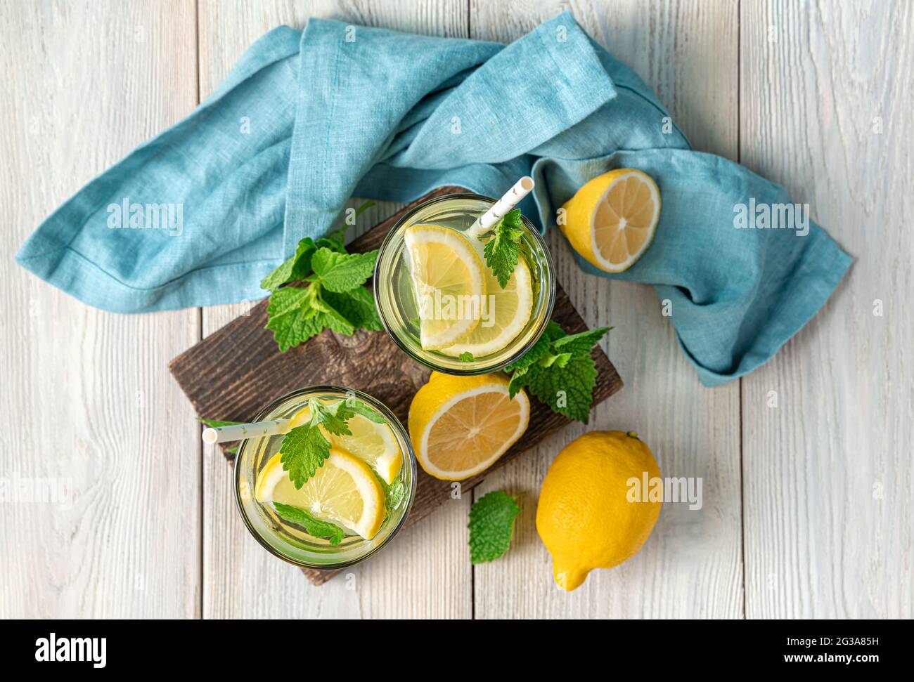 Refreshing lemonade and lemons with mint on a white background. Top ...