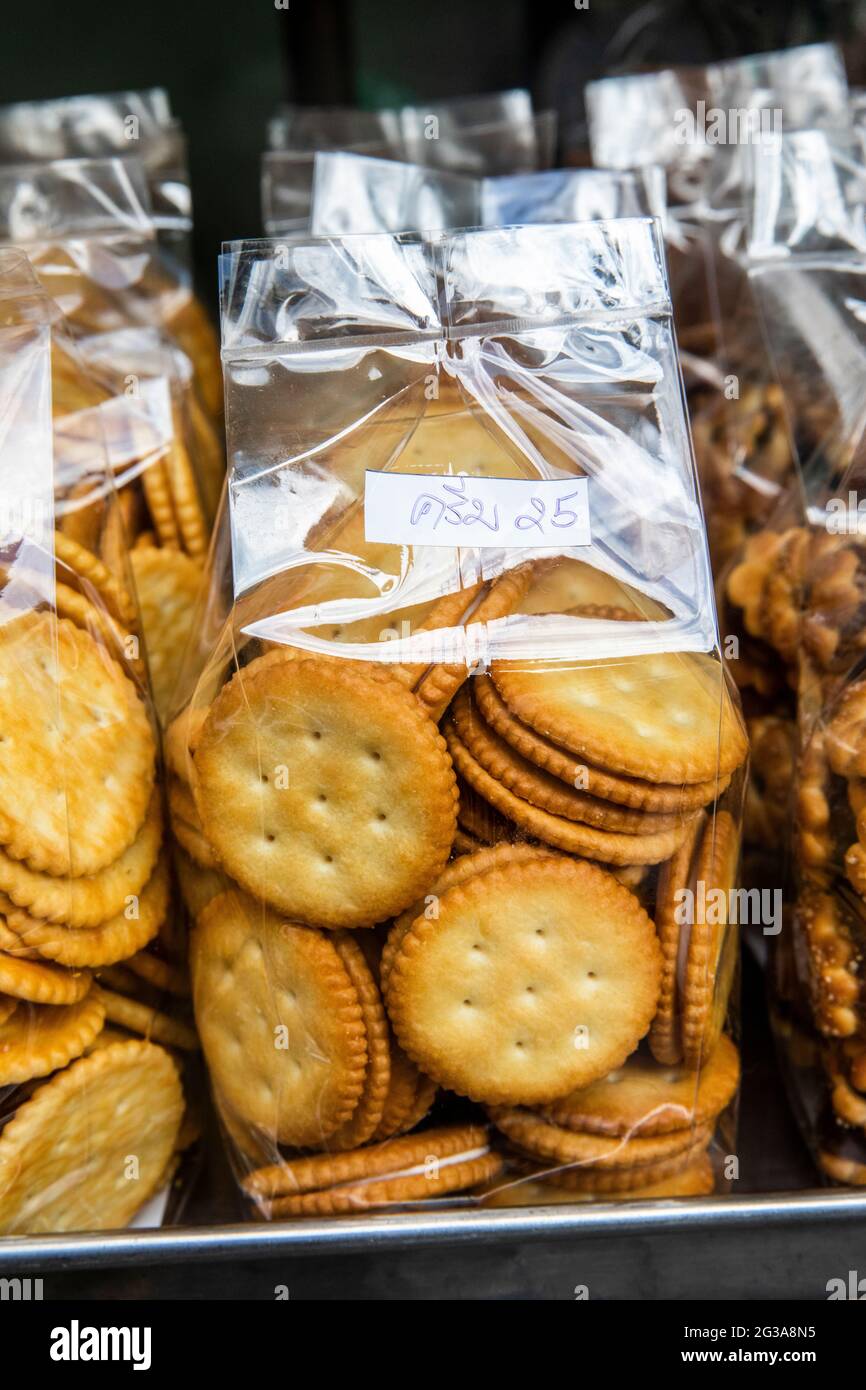 Packages of crackers and cookies are in neat plastic bags at a street ...