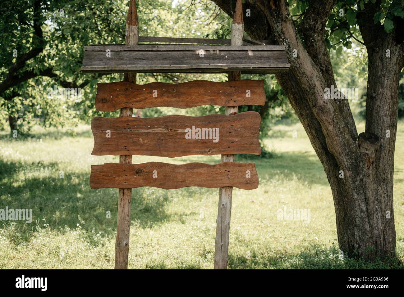 An old wooden signboard with copy space in the rural background, wooden ...
