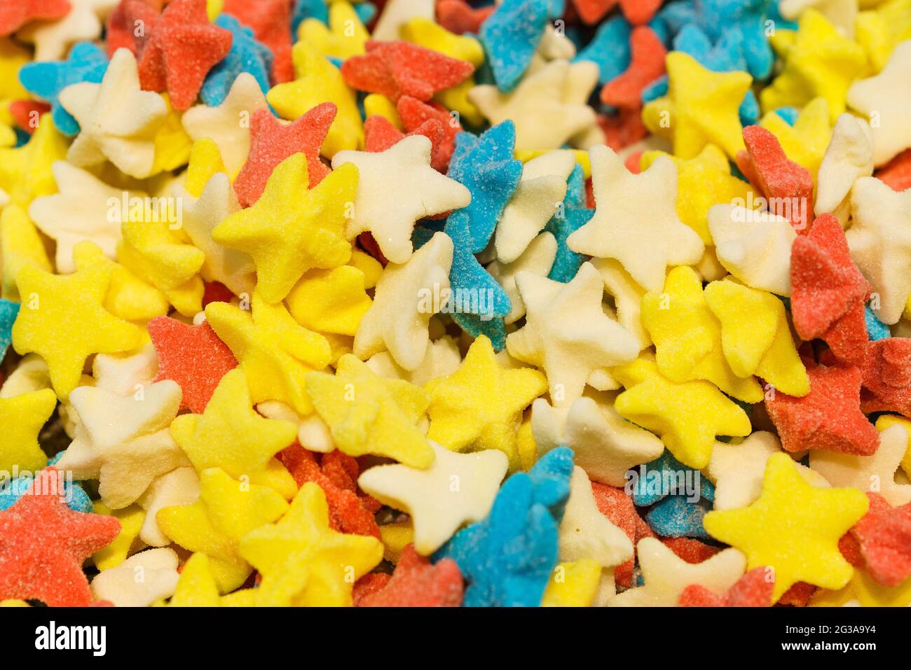 Multicolored gummy candies in form of stars. Bright candy background as ...