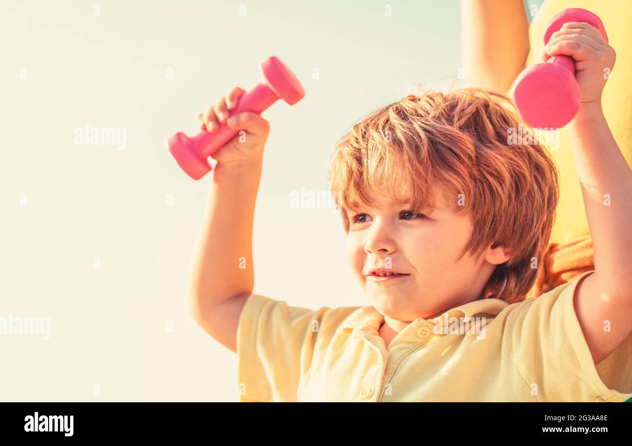 Strong kid boy exercising dumbbells hi-res stock photography and images ...