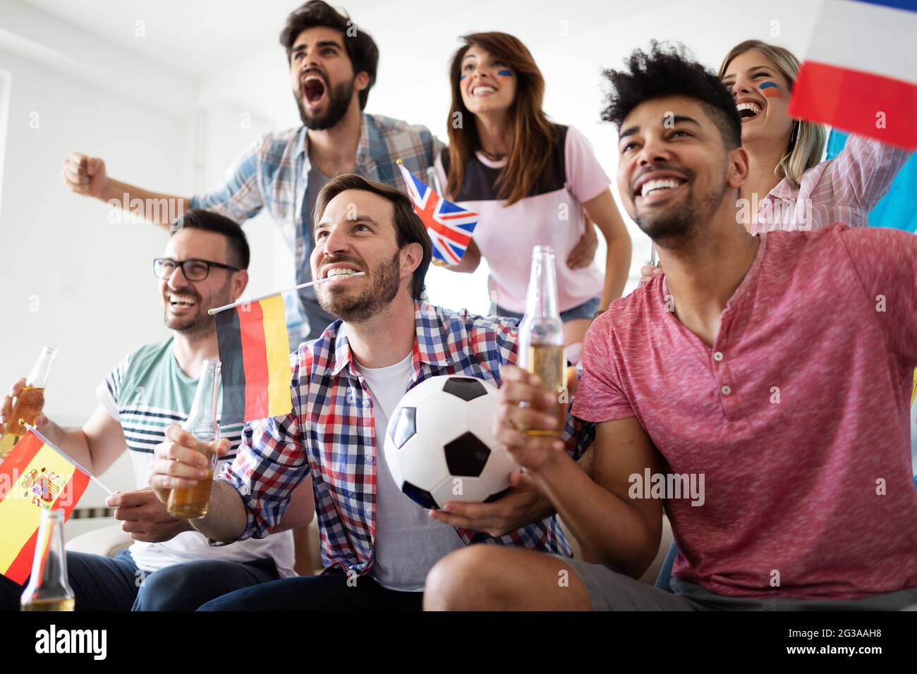 Group of friends having fun at home, watching game and enjoying ...