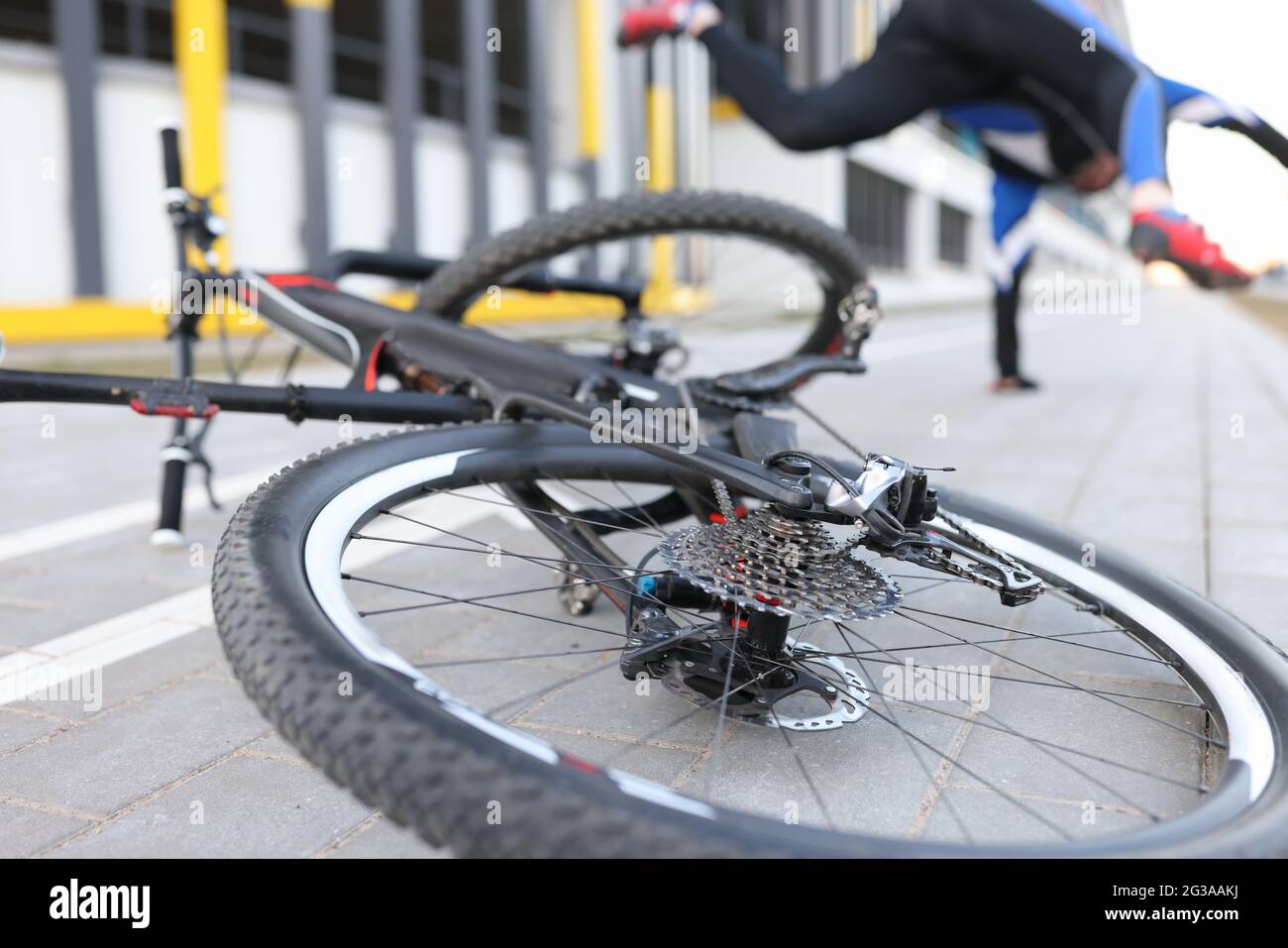 Man falling from bike on road closeup Stock Photo - Alamy