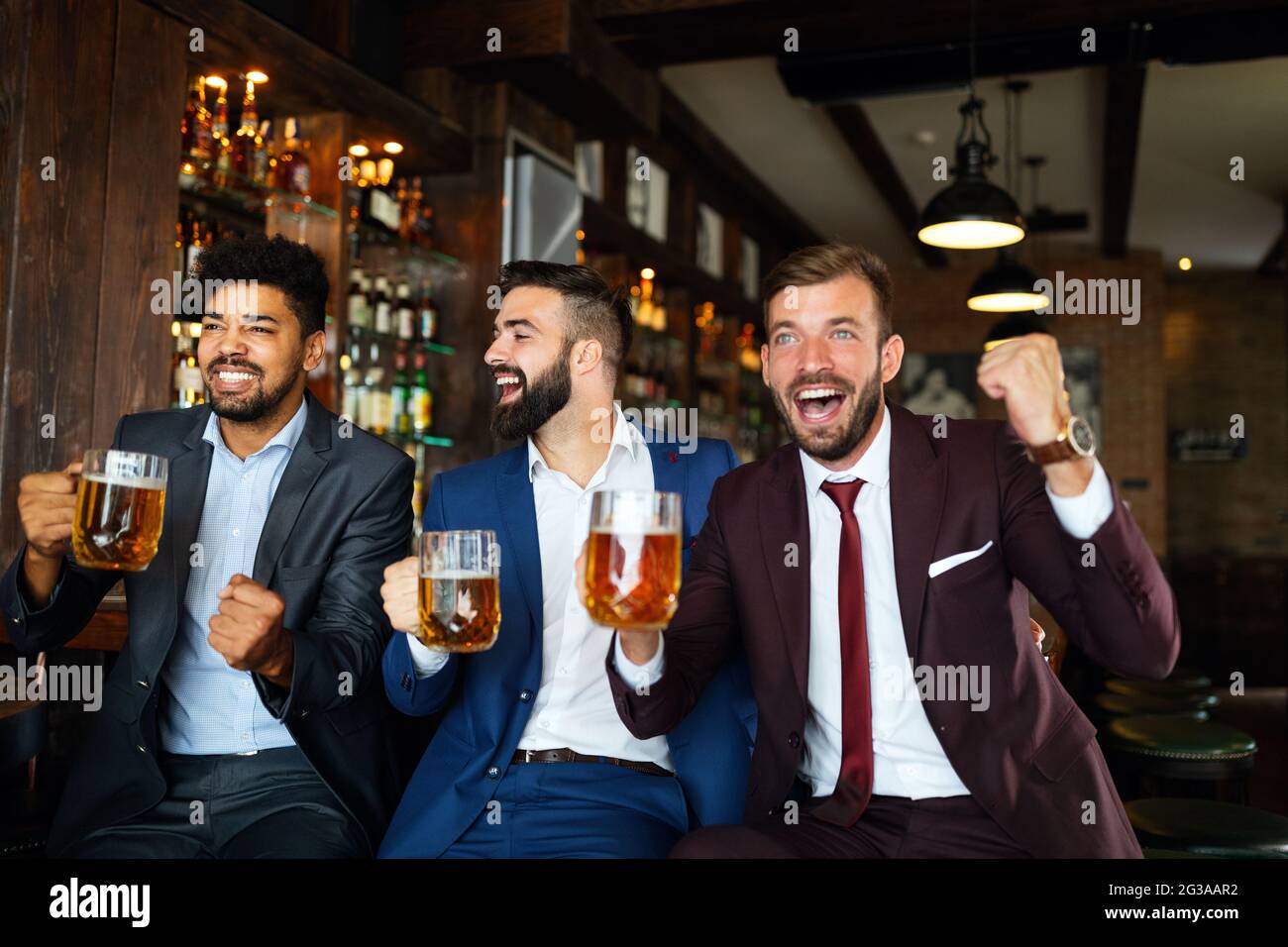 Business men in pub cheering for a sporting event Stock Photo - Alamy