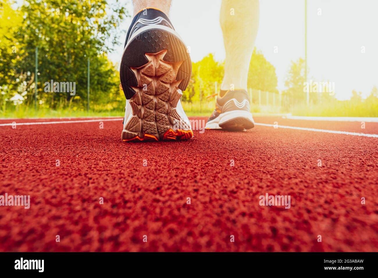 Athlete runner feet running on treadmill closeup on shoe. Rear view ...