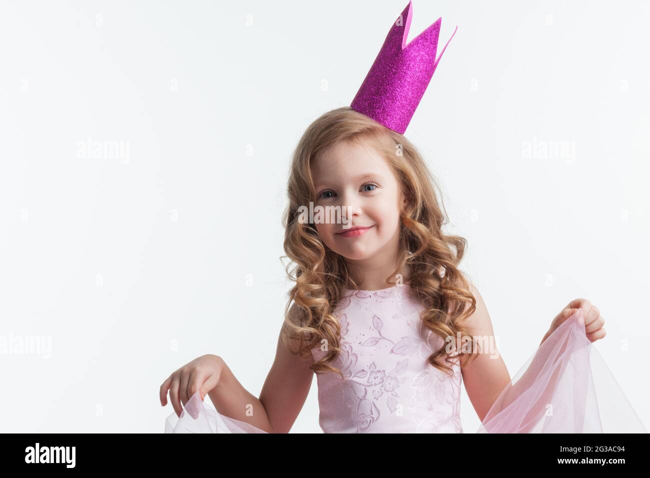Little princess girl in pink crown and beautiful dress on white ...